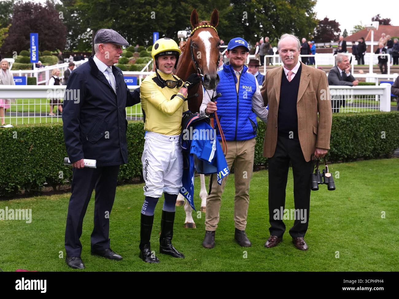 Trainer Karl Burke (left) and jockey Clifford Lee (second left) after ...