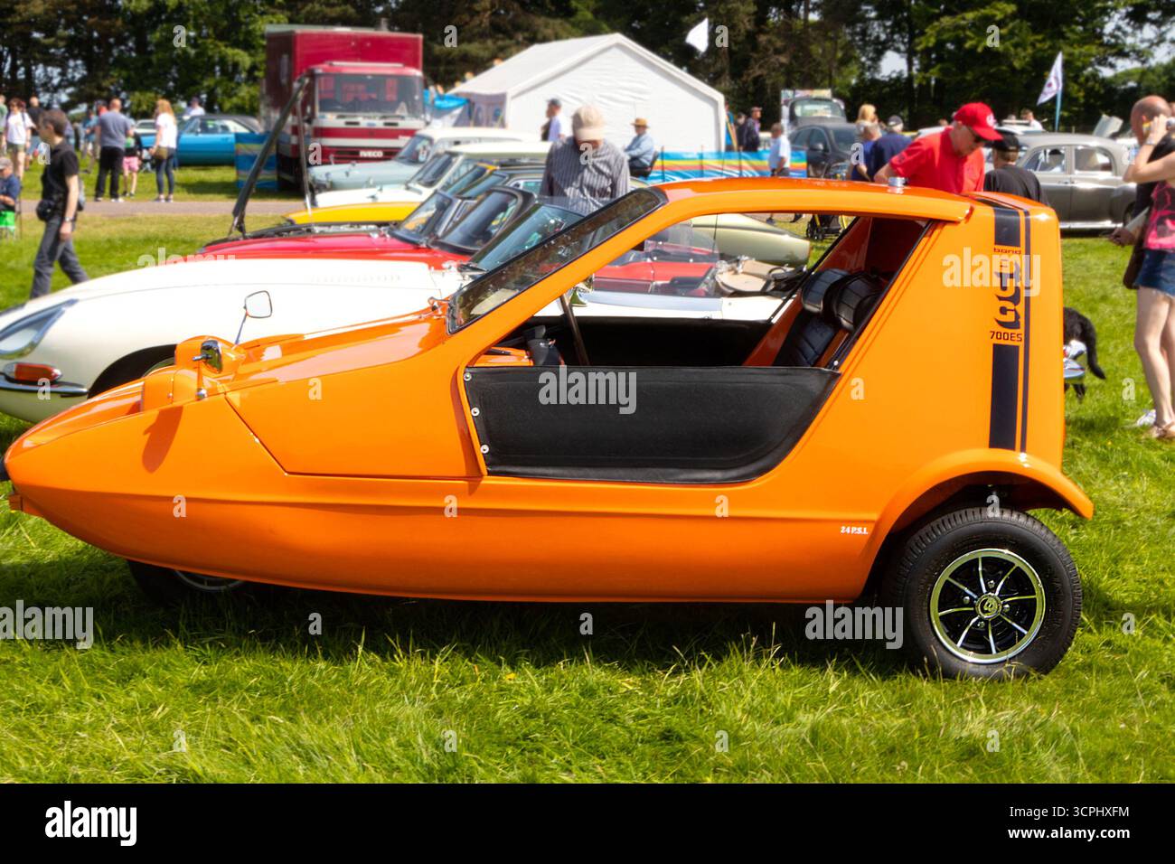 Bright orange vintage Bond Bug three-wheeler car on display at an ...