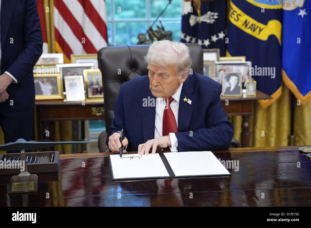 United States President Donald J Trump signs one of several Executive ...