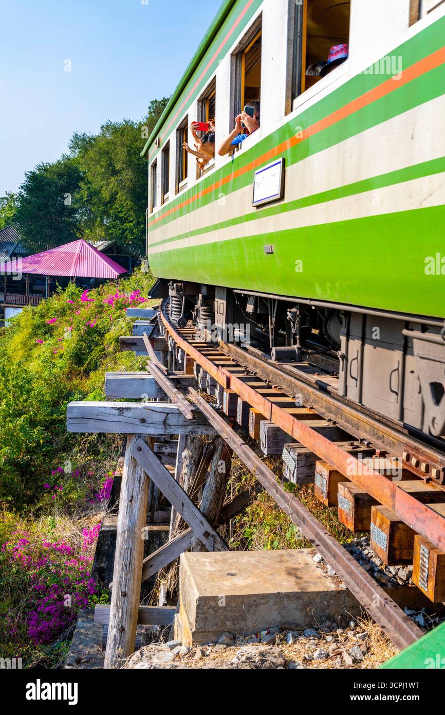 A passenger diesel locomotive train,carrying tourists,moving slowly and ...