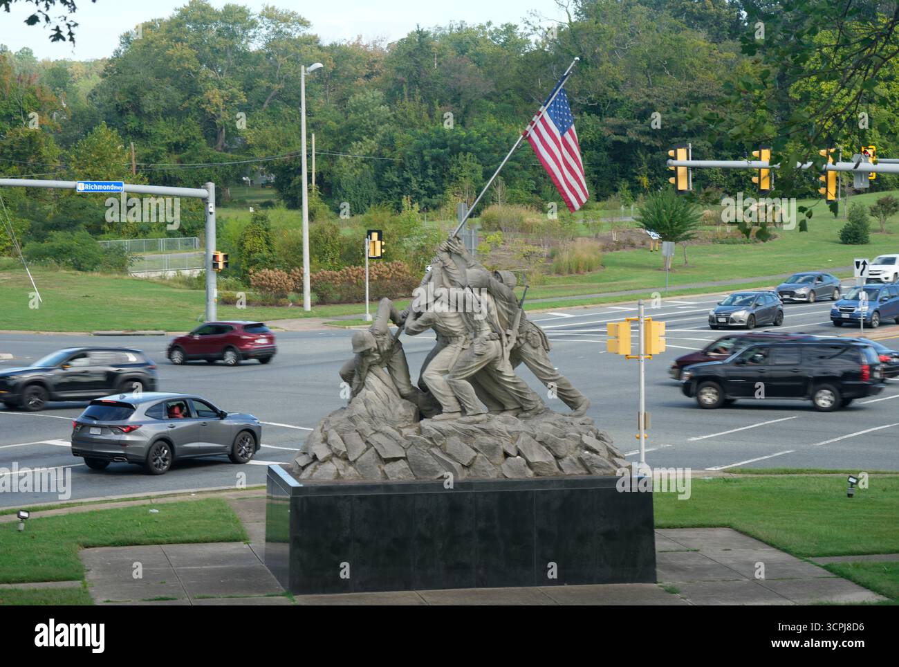 Vehicles drive past an Iwo Jima Memorial tribute statue near the ...