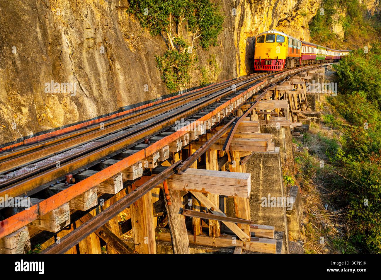 A passenger diesel locomotive train,carrying tourists,moving slowly and ...