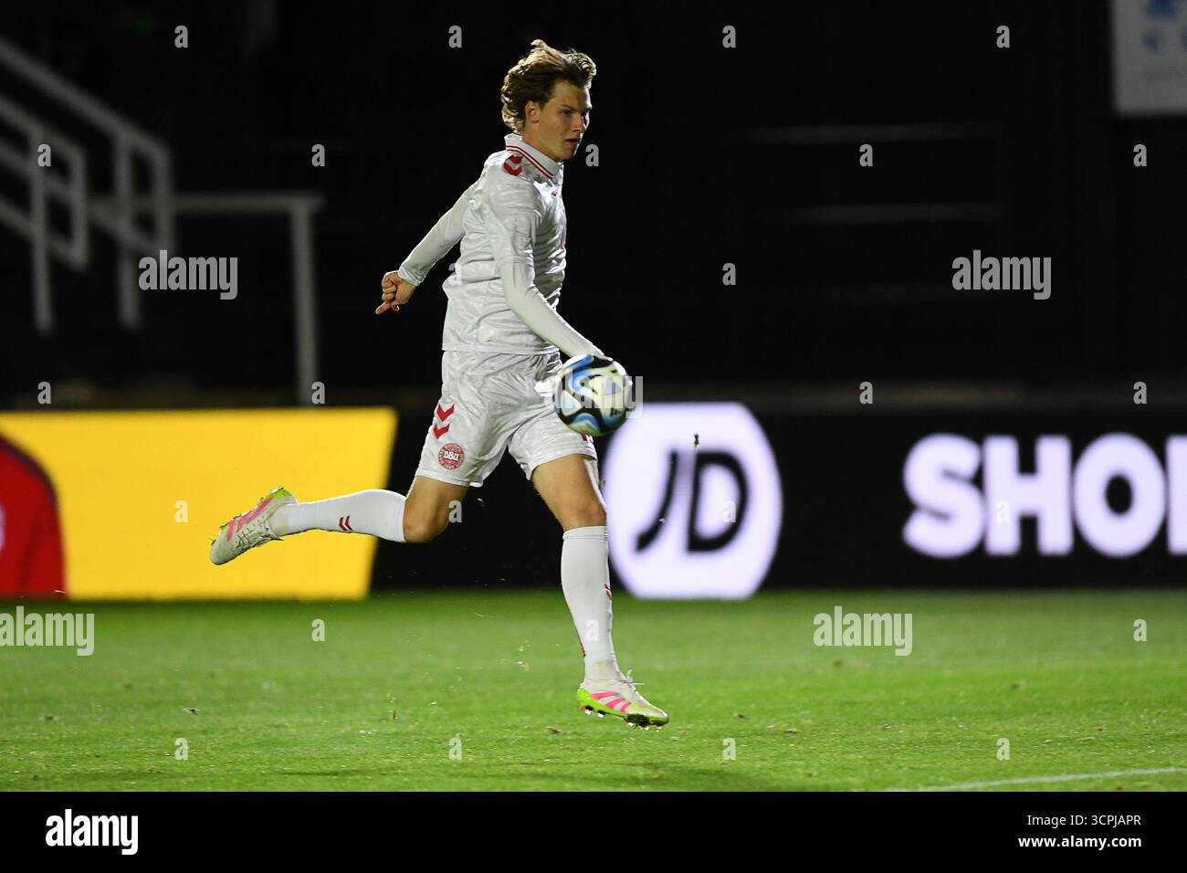 Rodney Parade August Priske of Denmark flicks the ball over the top of ...