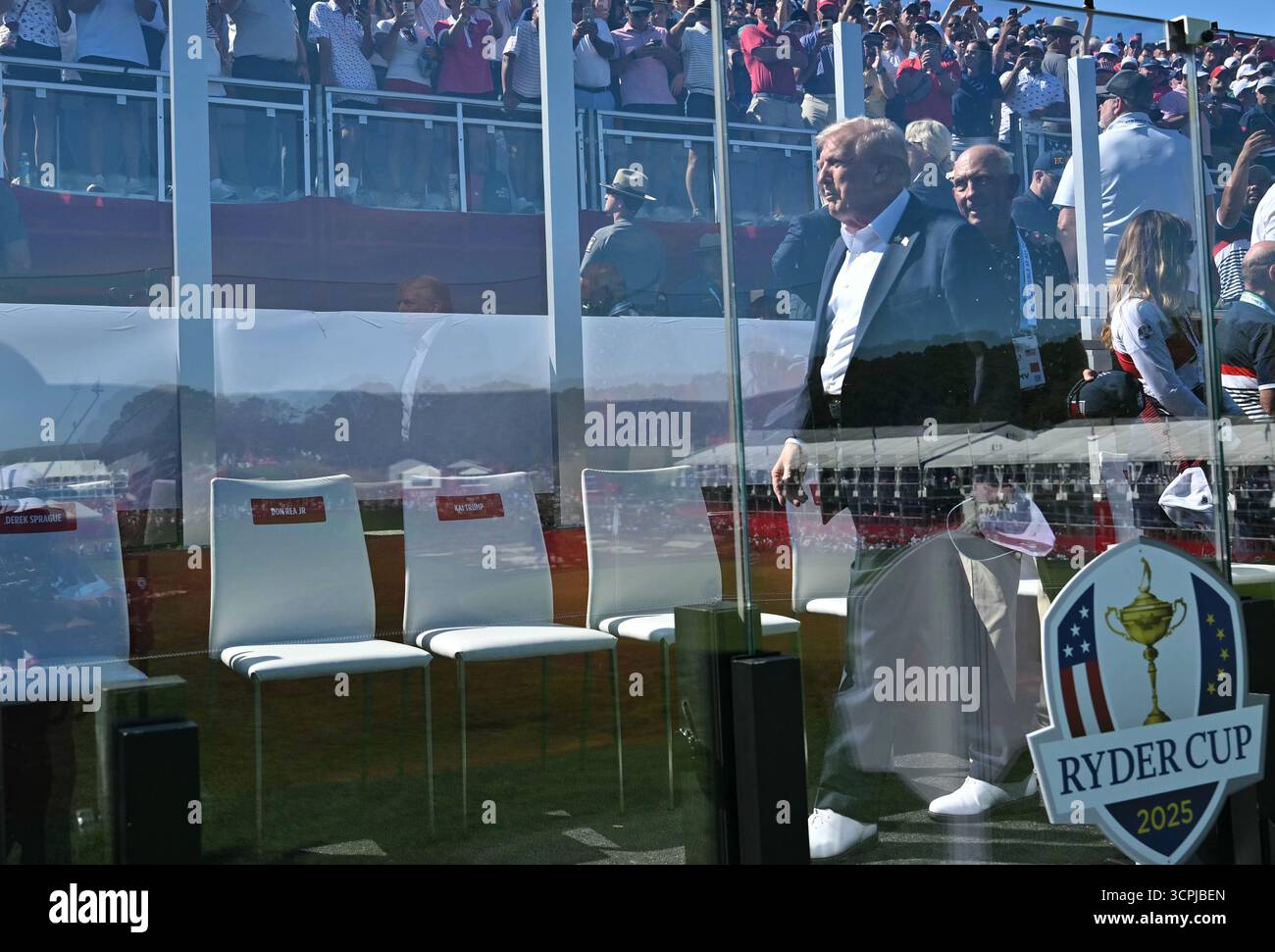 President Donald Trump steps behind protective glass as he attends the ...