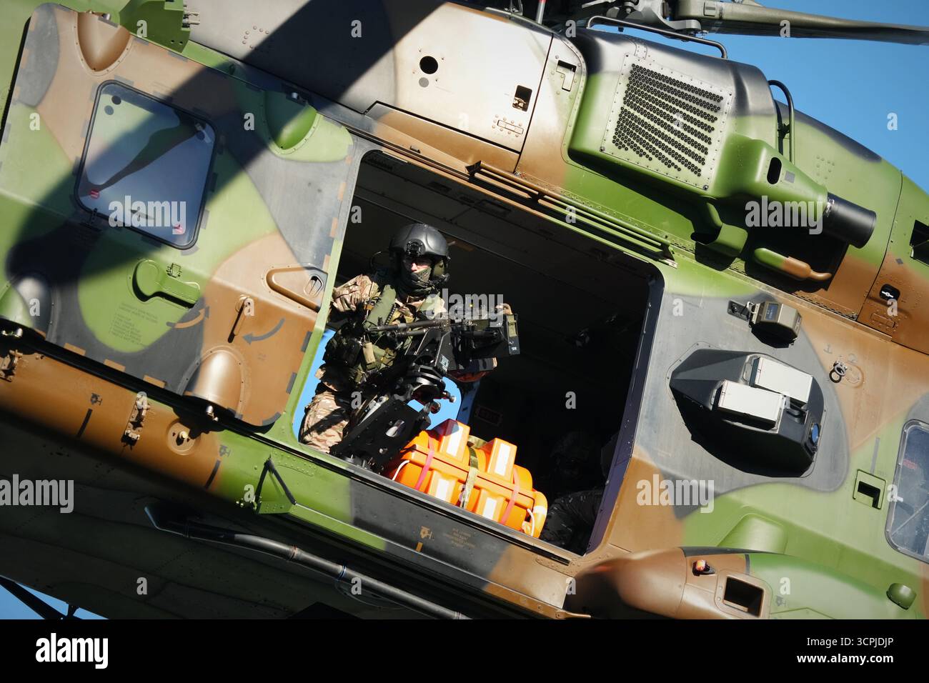 A crew member looks out of a French army NH 90 Caiman helicopter during ...