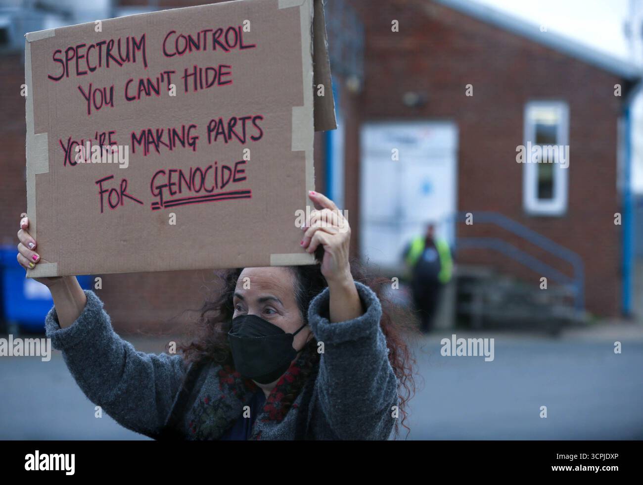 A protester holds a placard saying ‘Spectrum Control You Can’t Hide You ...
