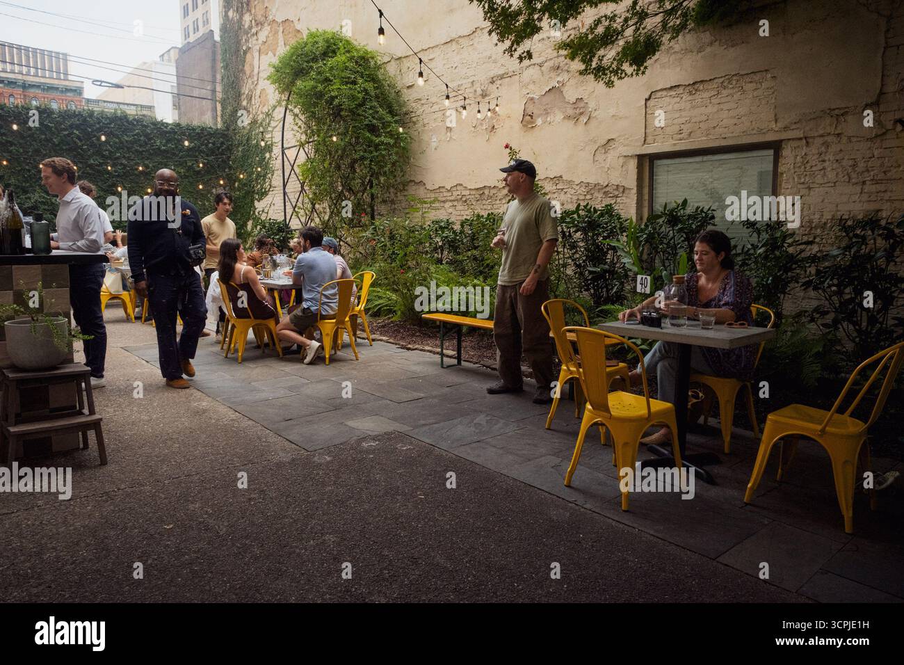 Guests attend the "The Golden Age Wine Garden x Chef Hunter Evans ...