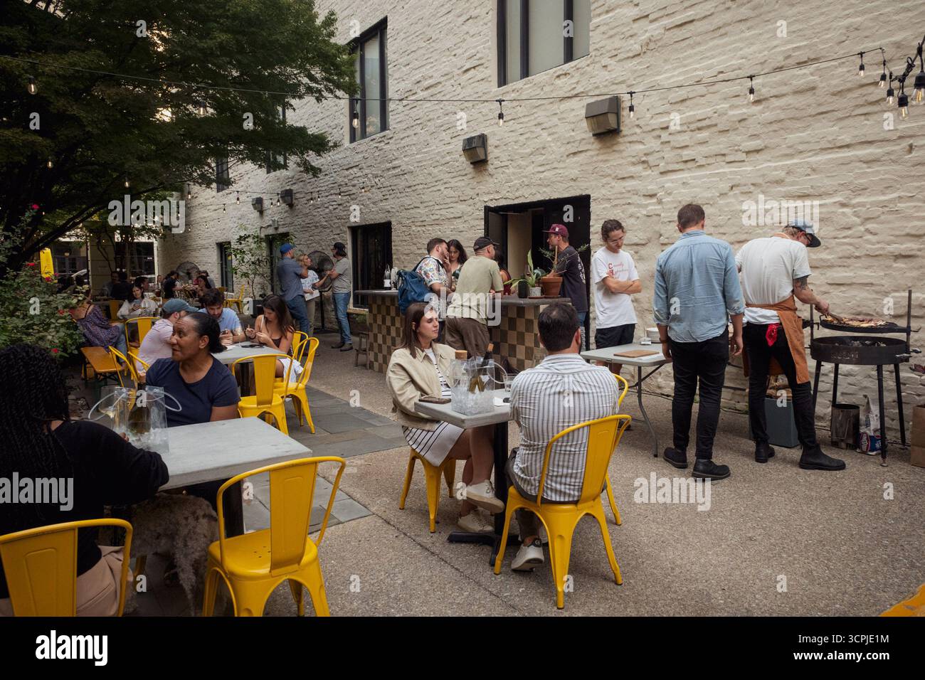 Guests attend the "The Golden Age Wine Garden x Chef Hunter Evans ...
