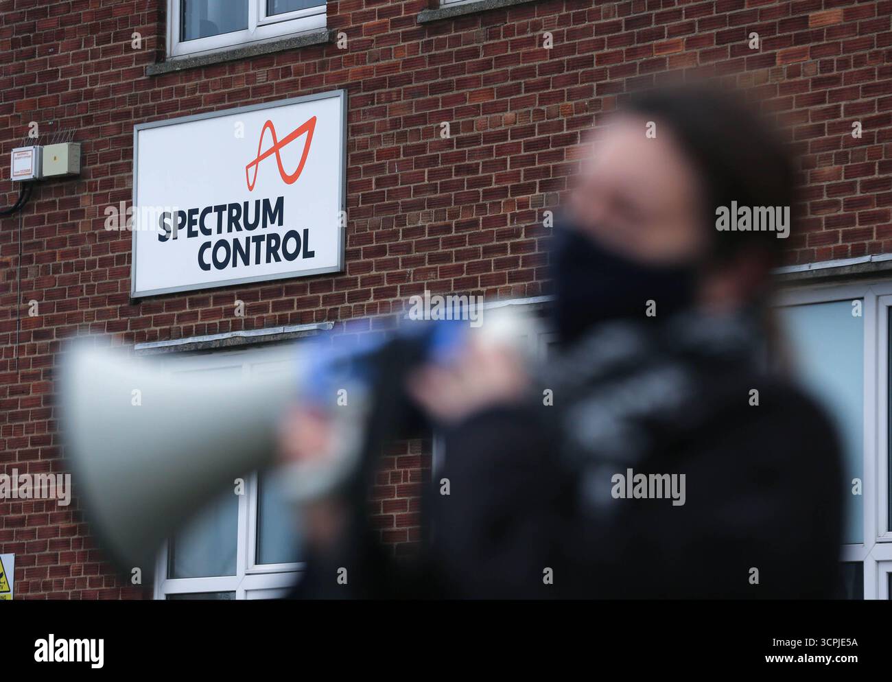 A protester chants through a megaphone during the protest. Protesters ...