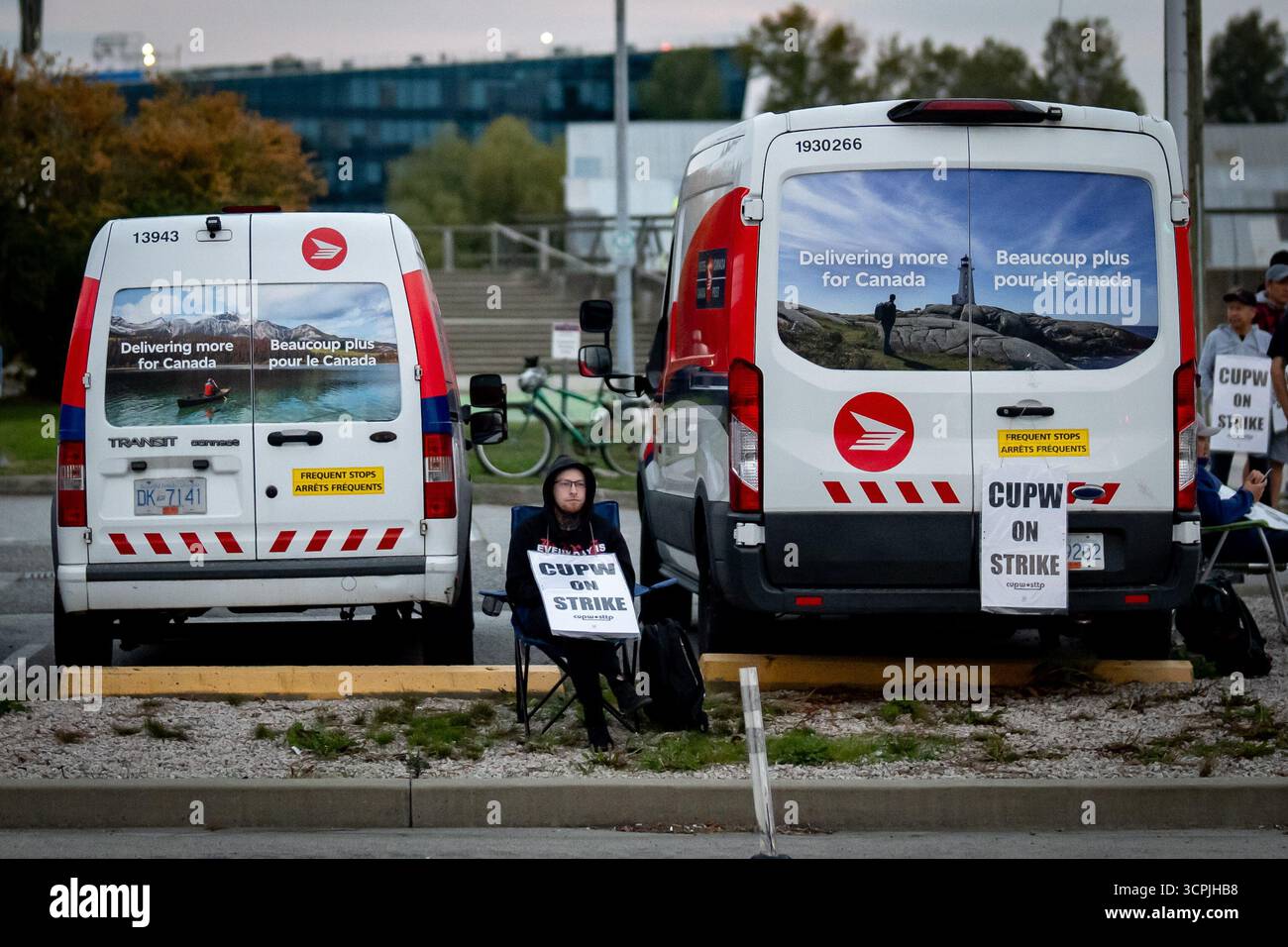 A member of the Canadian Union of Postal Workers pickets outside of a ...