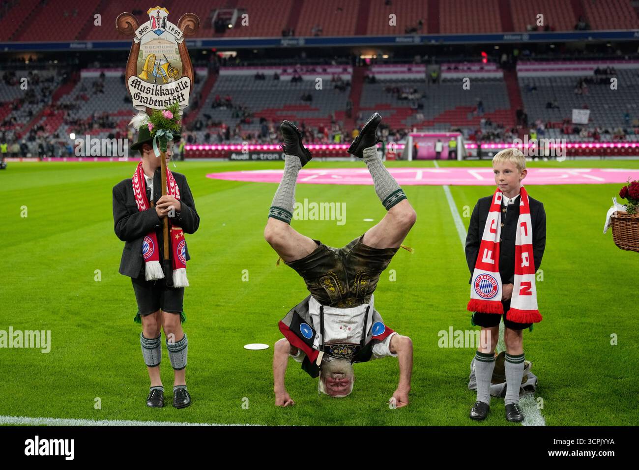A man in traditional Bavarian costume performs before the Bundesliga ...
