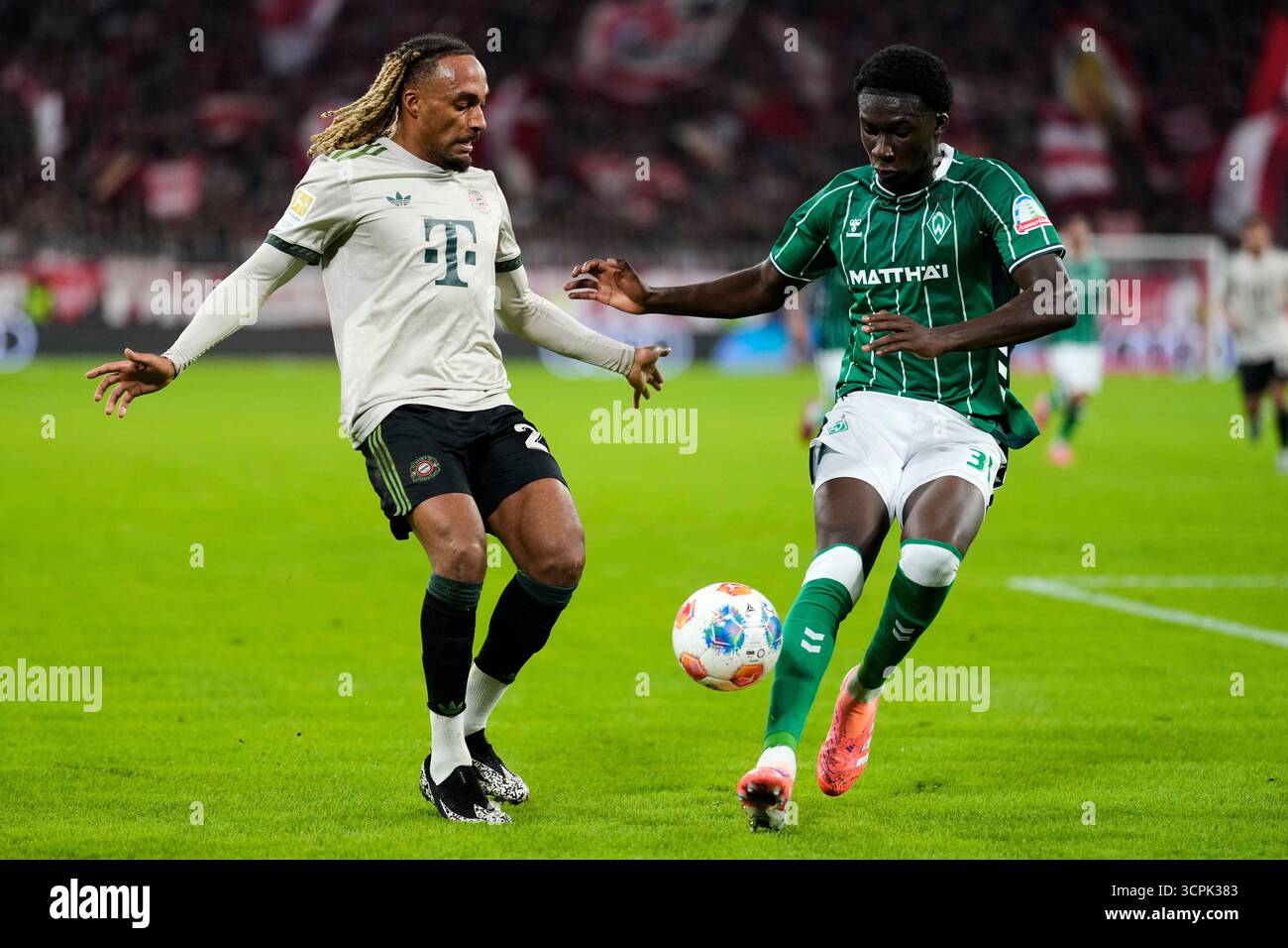 Bayern's Sacha Boey, left, and Bremen's Karim Coulibaly vie for the ...