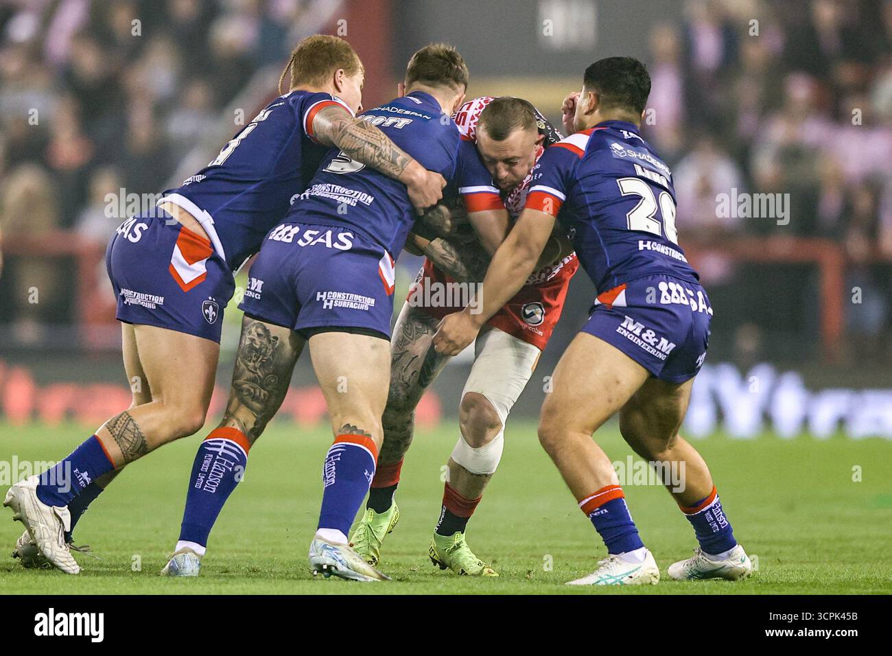 Josh Charley of Leigh Leopards is tackled by Tom Johnstone of Wakefield ...