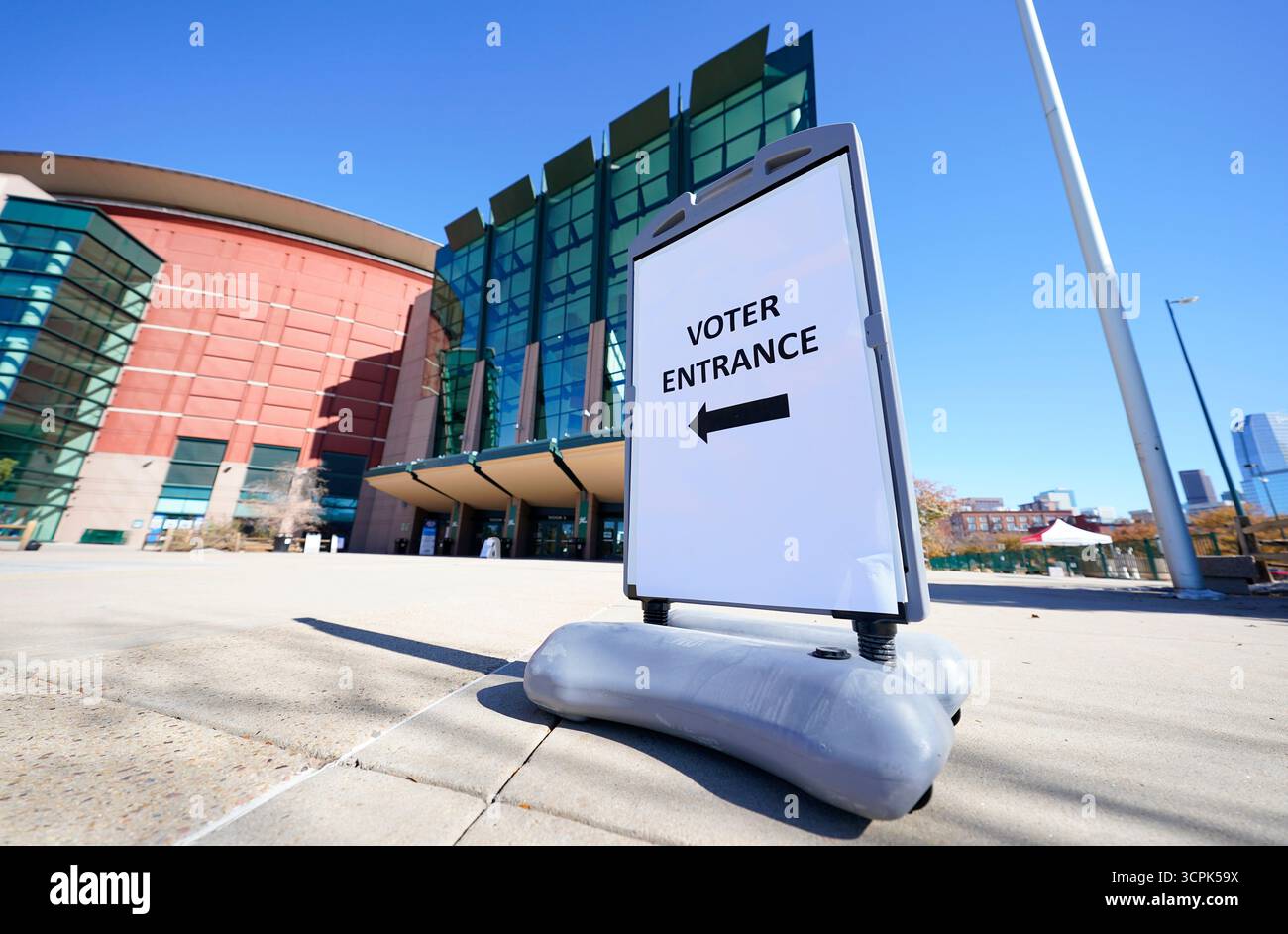 FILE - A sign directs voters to cast their ballots in the atrium of ...