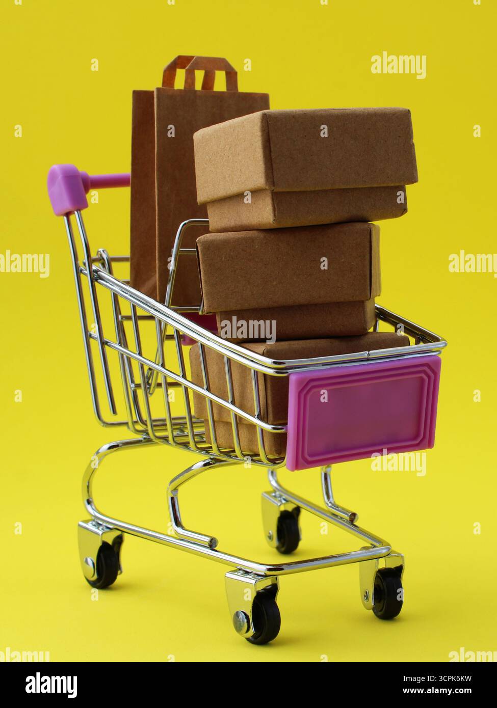 Shopping cart with cardboard boxes and bag Stock Photo - Alamy