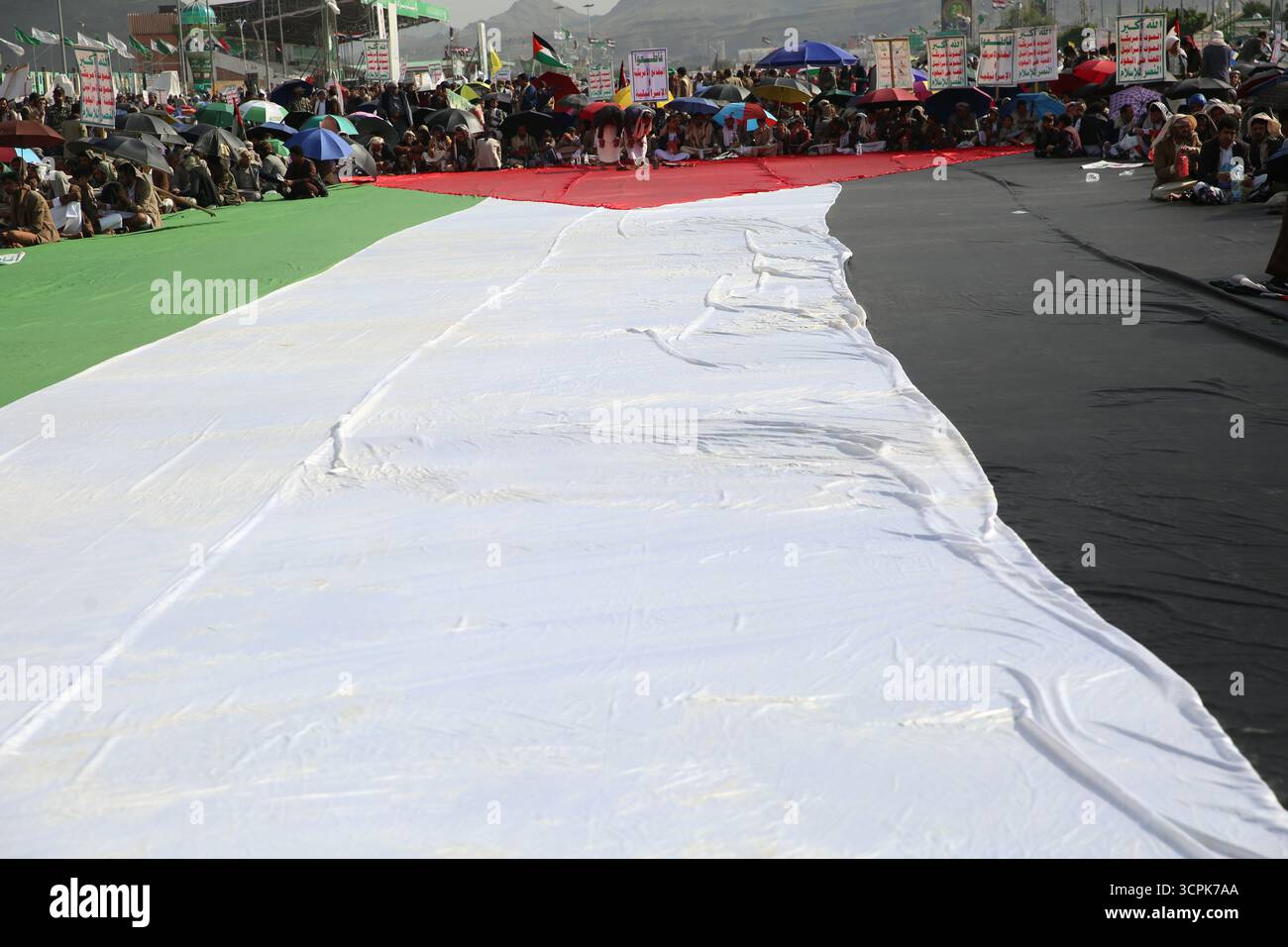 Houthi supporters gather around a large Palestinian flag during an anti ...