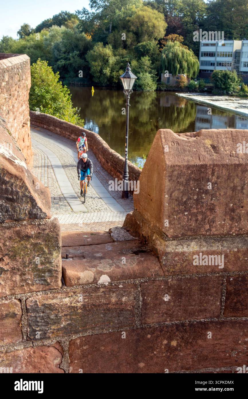 People cycling on the roman Chester city walls above the river Dee in ...