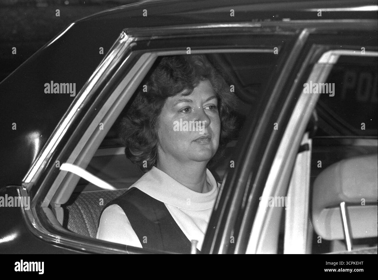 FILE - Sara Jane Moore rides in the backseat of a car on her way to ...