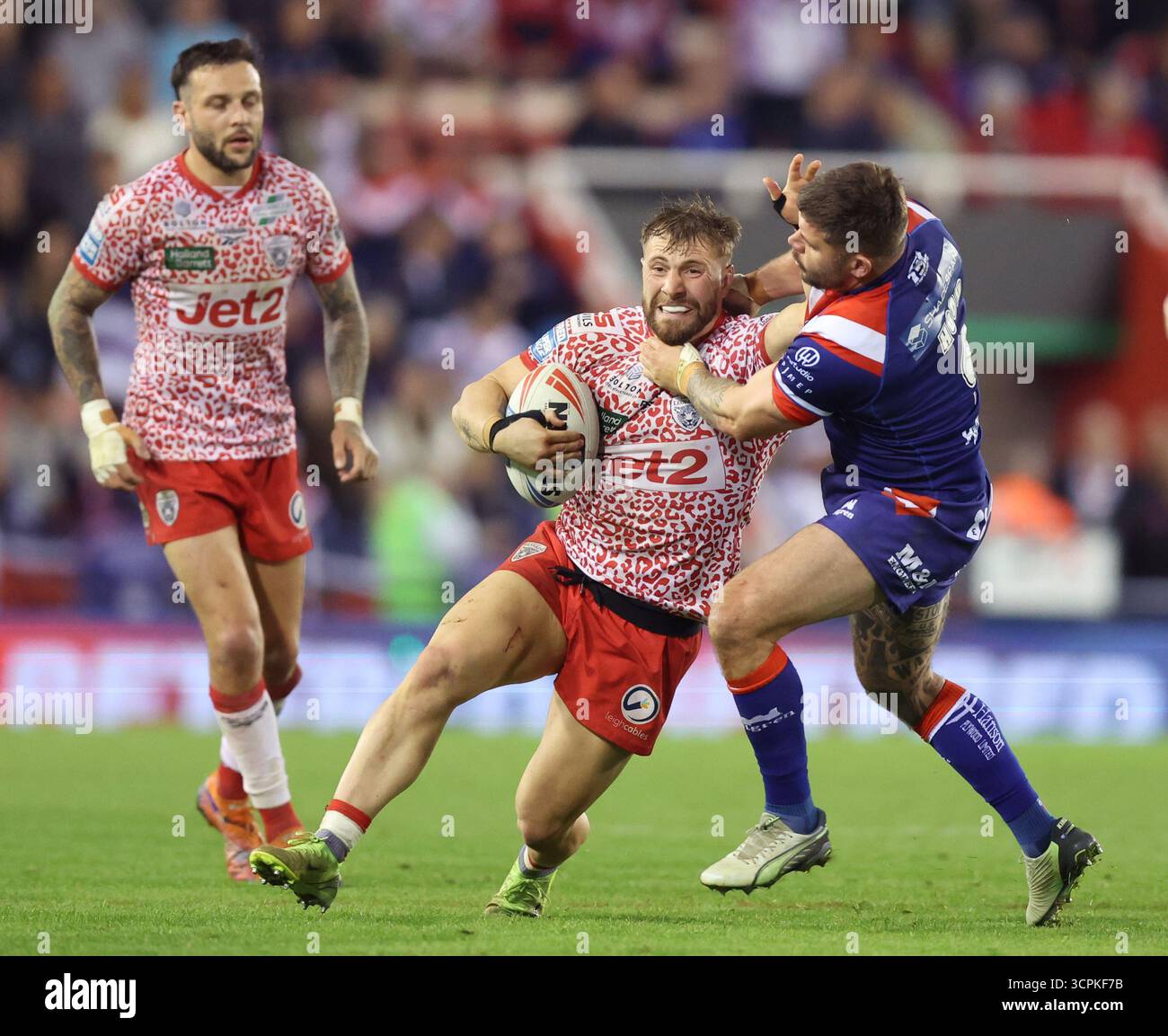 Leigh Leopards' Matt Davis is tackled by Wakefield Trinity's Liam Hood ...