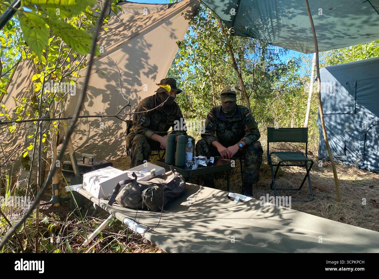 Sakiai, Lithuania. 21st Sep, 2025. Two Bundeswehr soldiers sit in their ...