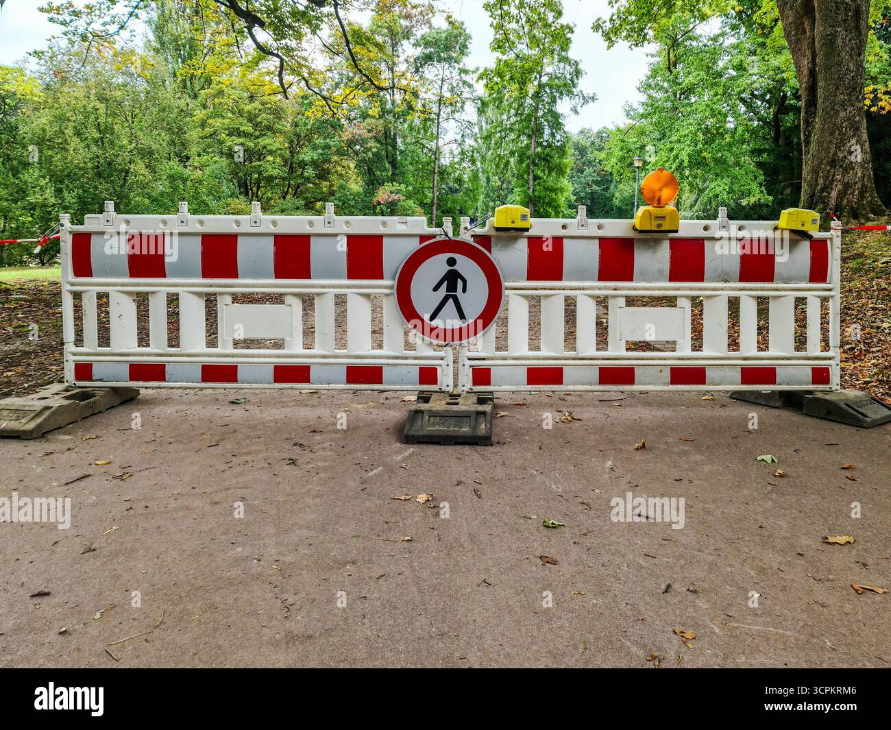 Bochum, Germany - 25. September 2025: Park path blocked by a plastic ...