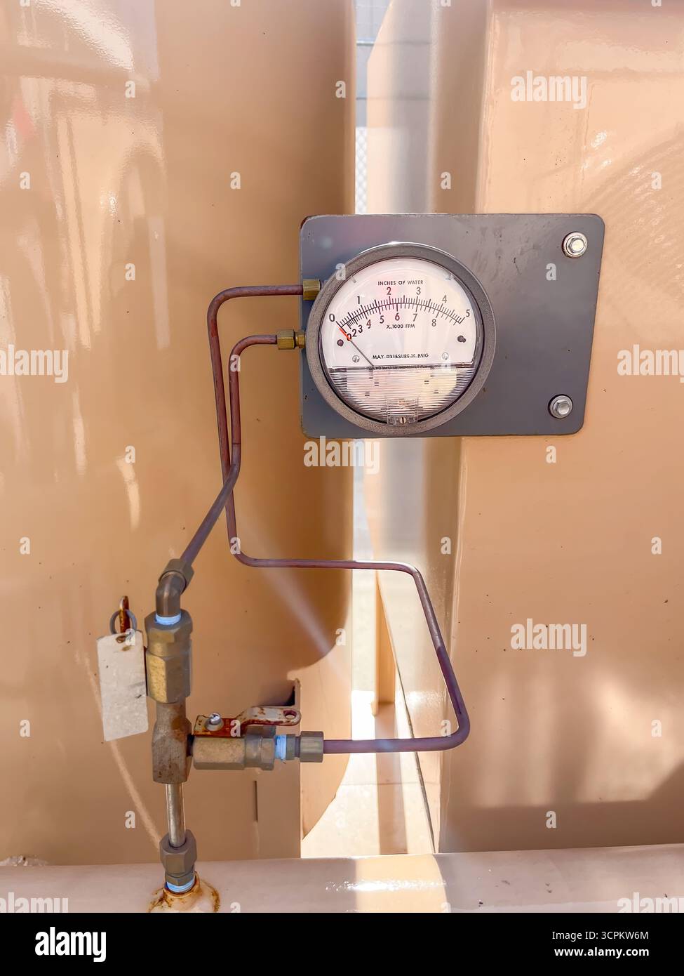 Pressure gauge on a piping system at a commercial facility during ...