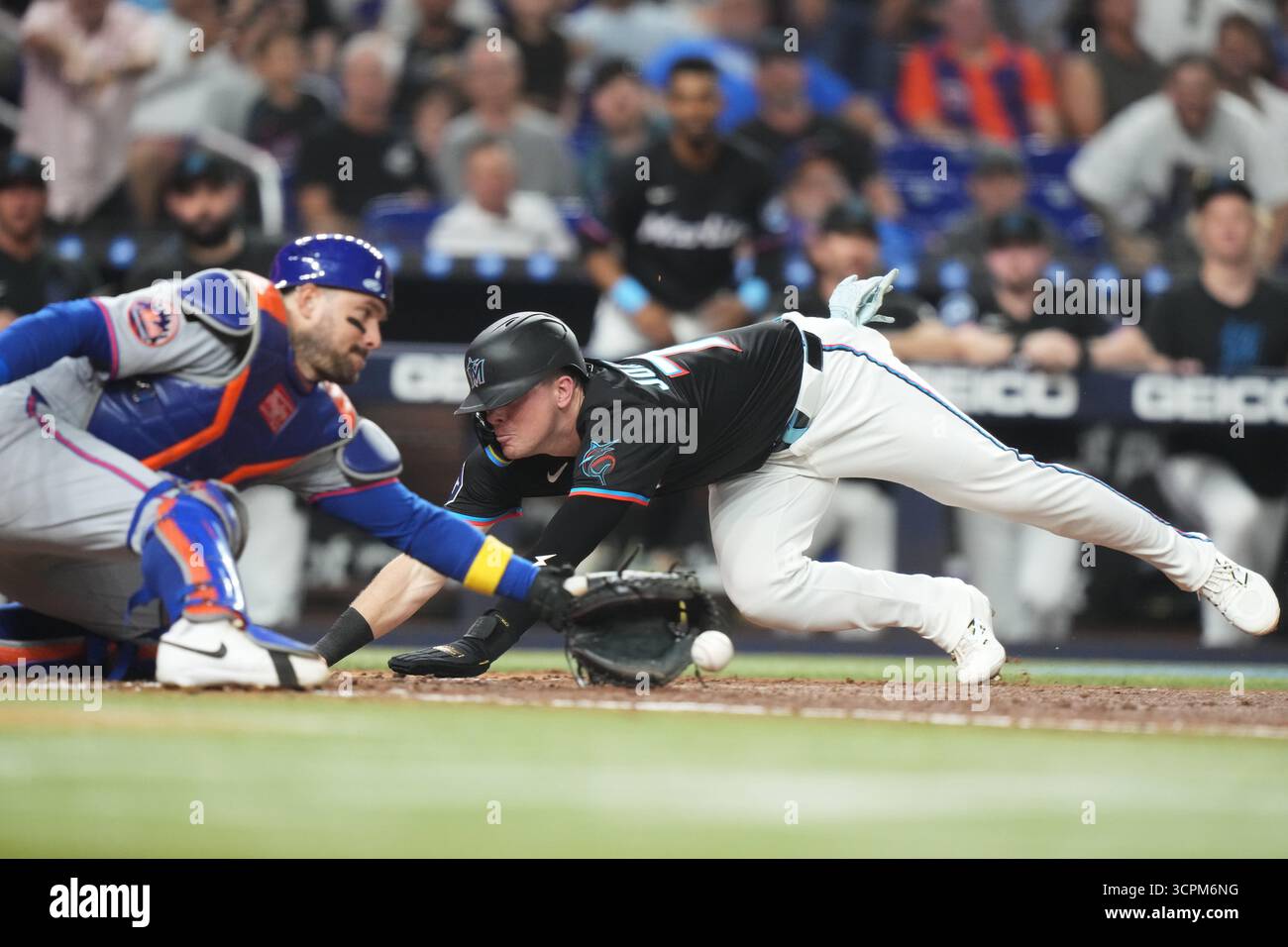 Miami Marlins' Troy Johnston, right, beats the throw to New York Mets ...