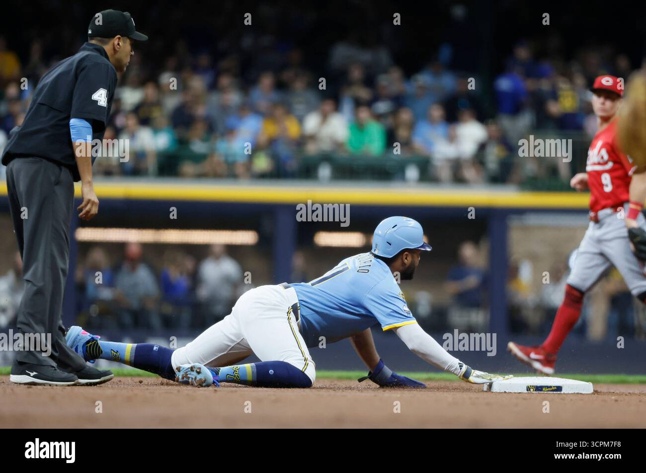 Second base umpire Gabe Morales watches as Milwaukee Brewers outfielder ...