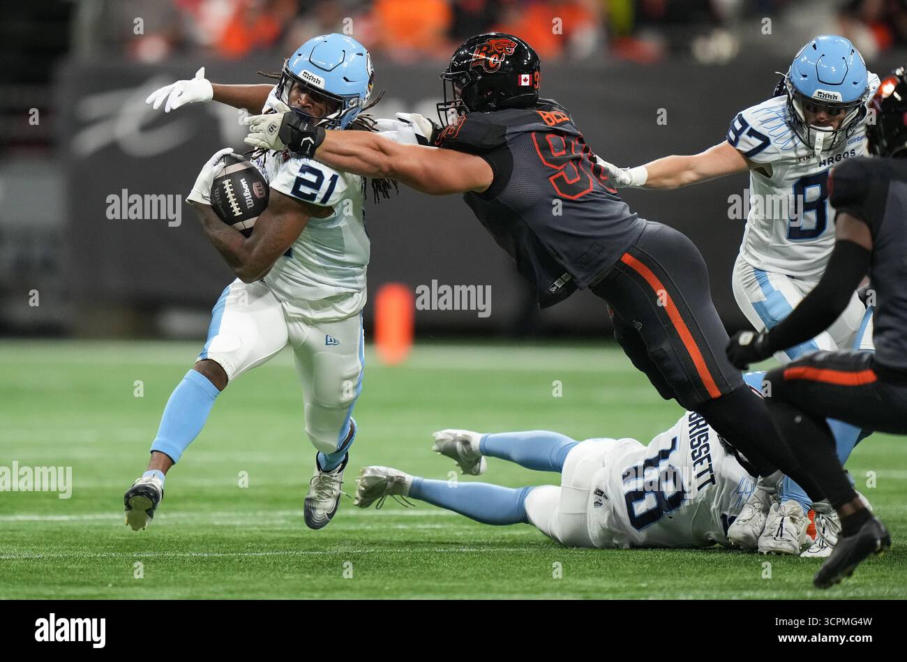 Toronto Argonauts' Spencer Brown (21) carries the ball as B.C. Lions ...