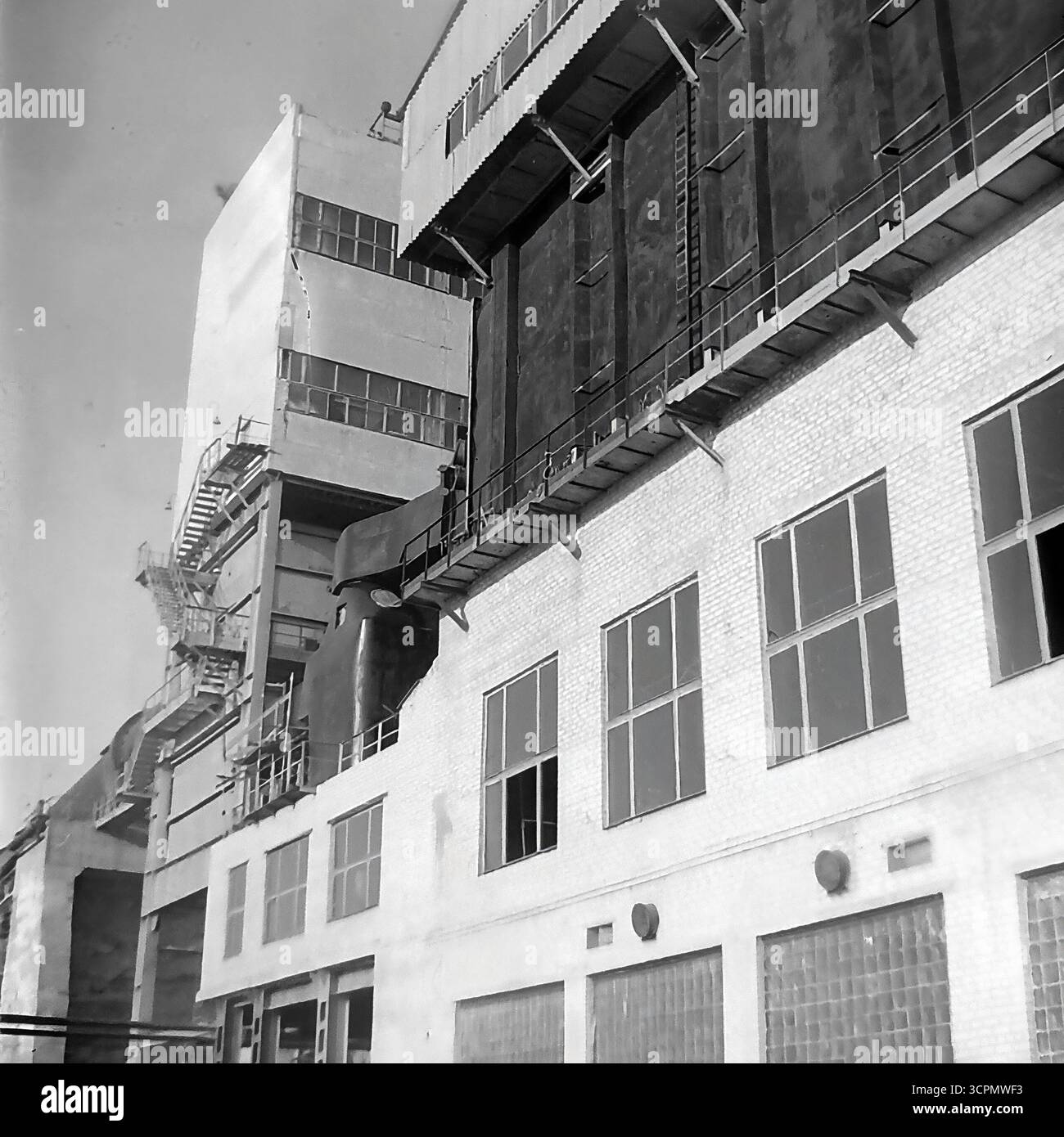 A low-angle shot captures the monumental industrial architecture of a ...