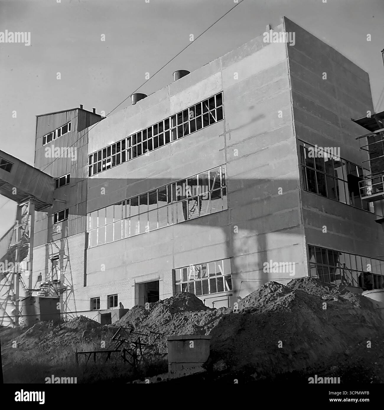 The stark, functionalist architecture of a new factory building at a ...