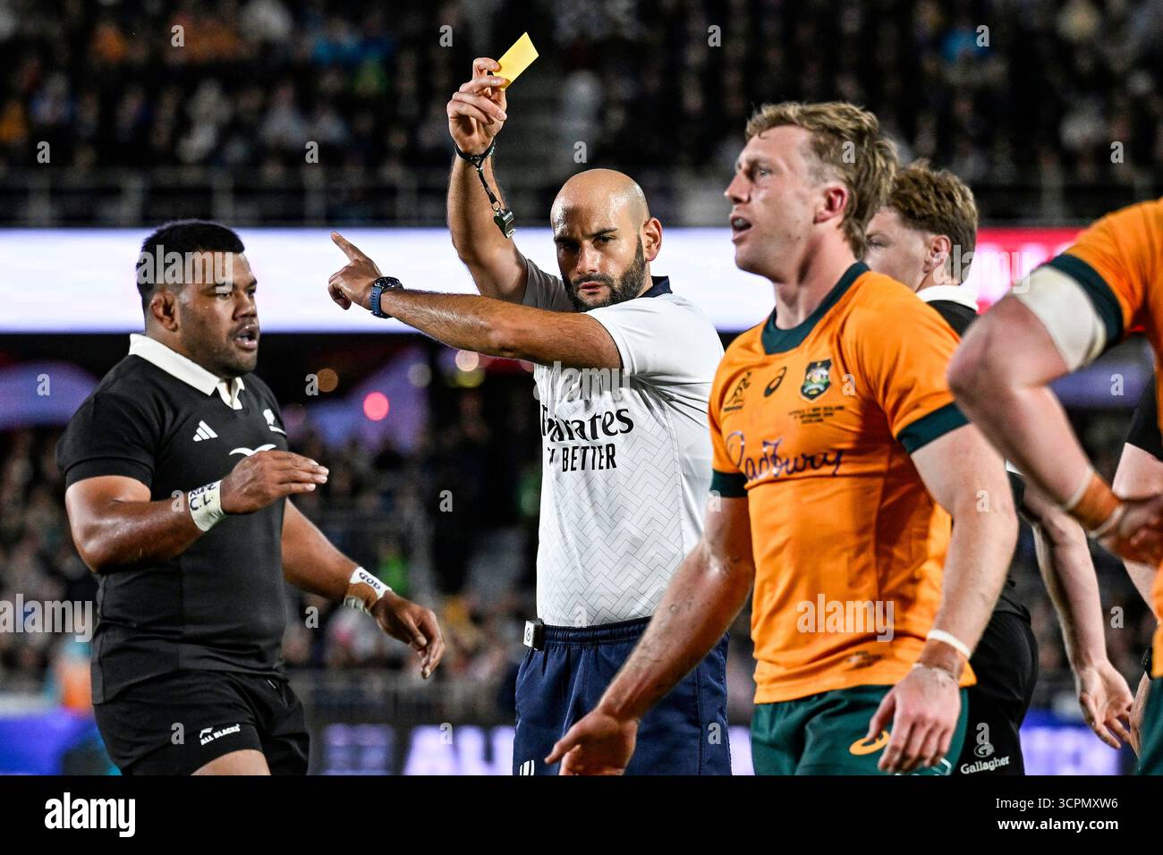 Match referee Andrea Piardi shows a yellow card to Australia's Harry ...
