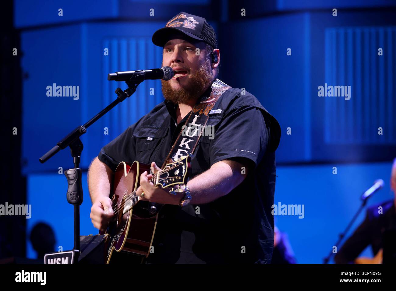 EDITORIAL USE ONLY Luke Combs performs during Grand Ole Opry: Live in ...