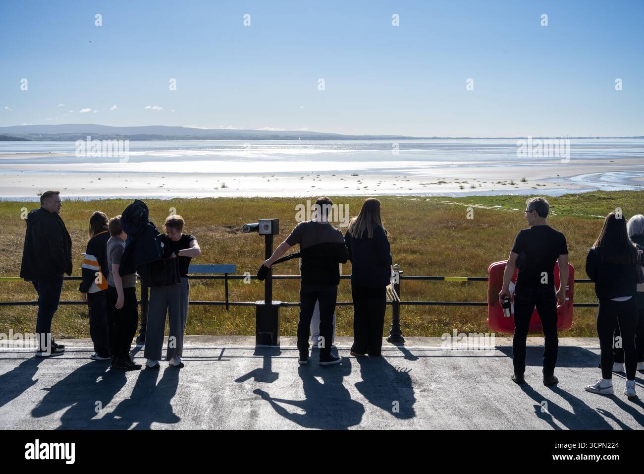 Visitors enjoying coastal views of Morecambe Bay from Grange-over-Sands ...