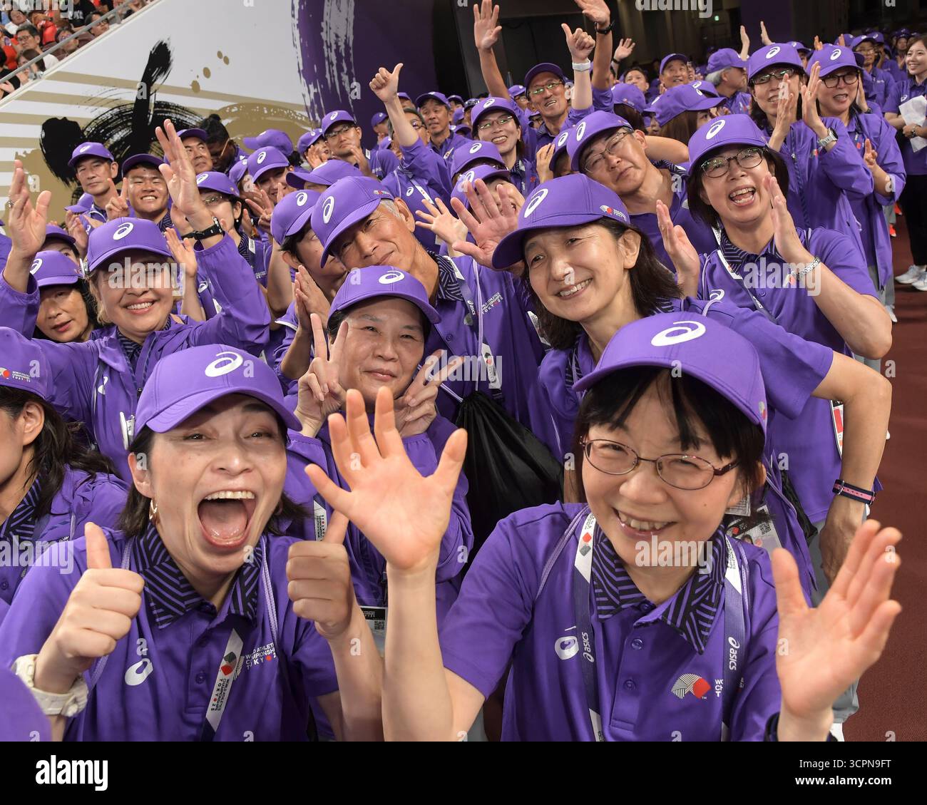 Volunteers celebrate there last night at the World Athletics ...