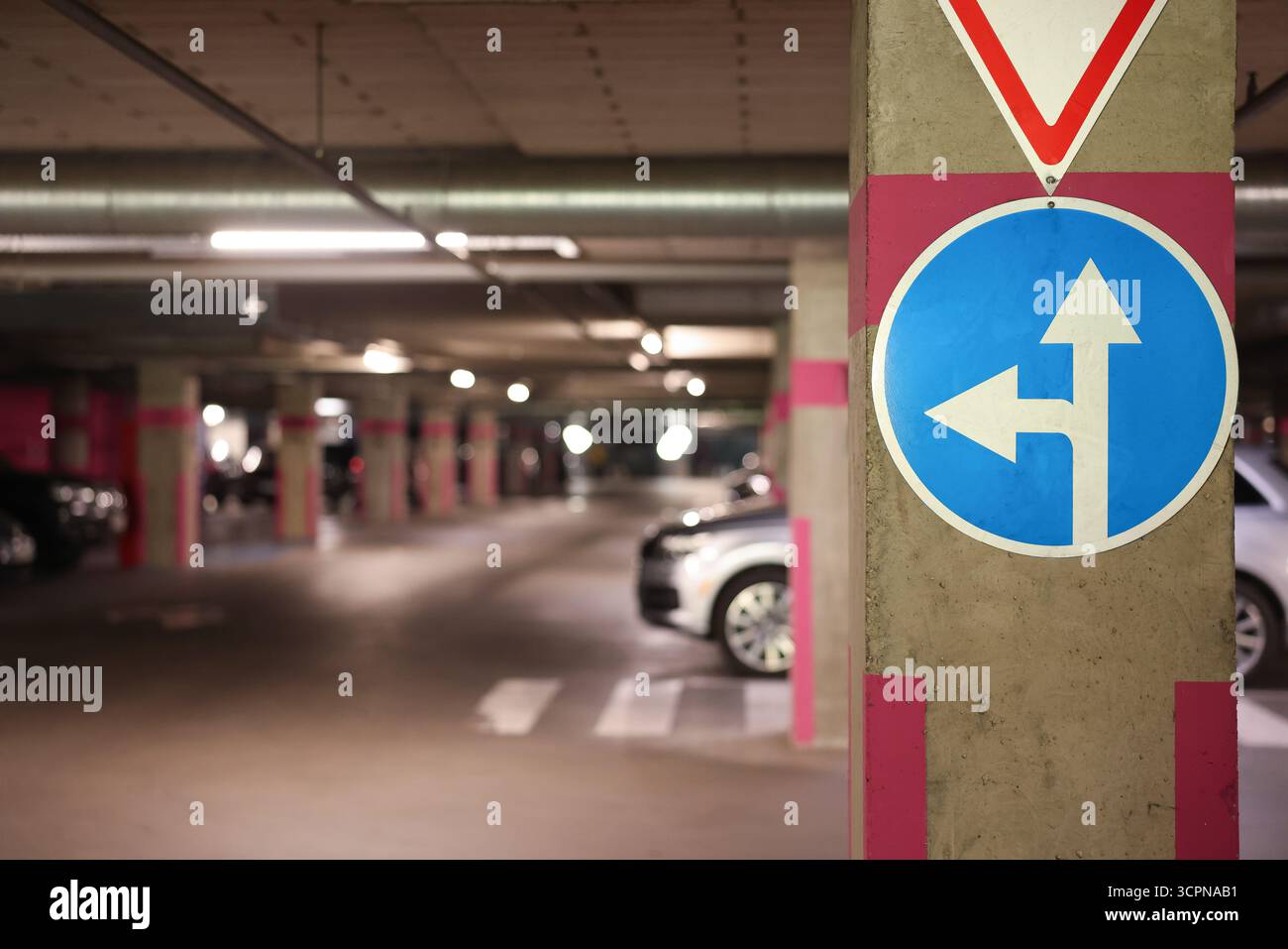 Traffic signs on column in underground parking Stock Photo - Alamy