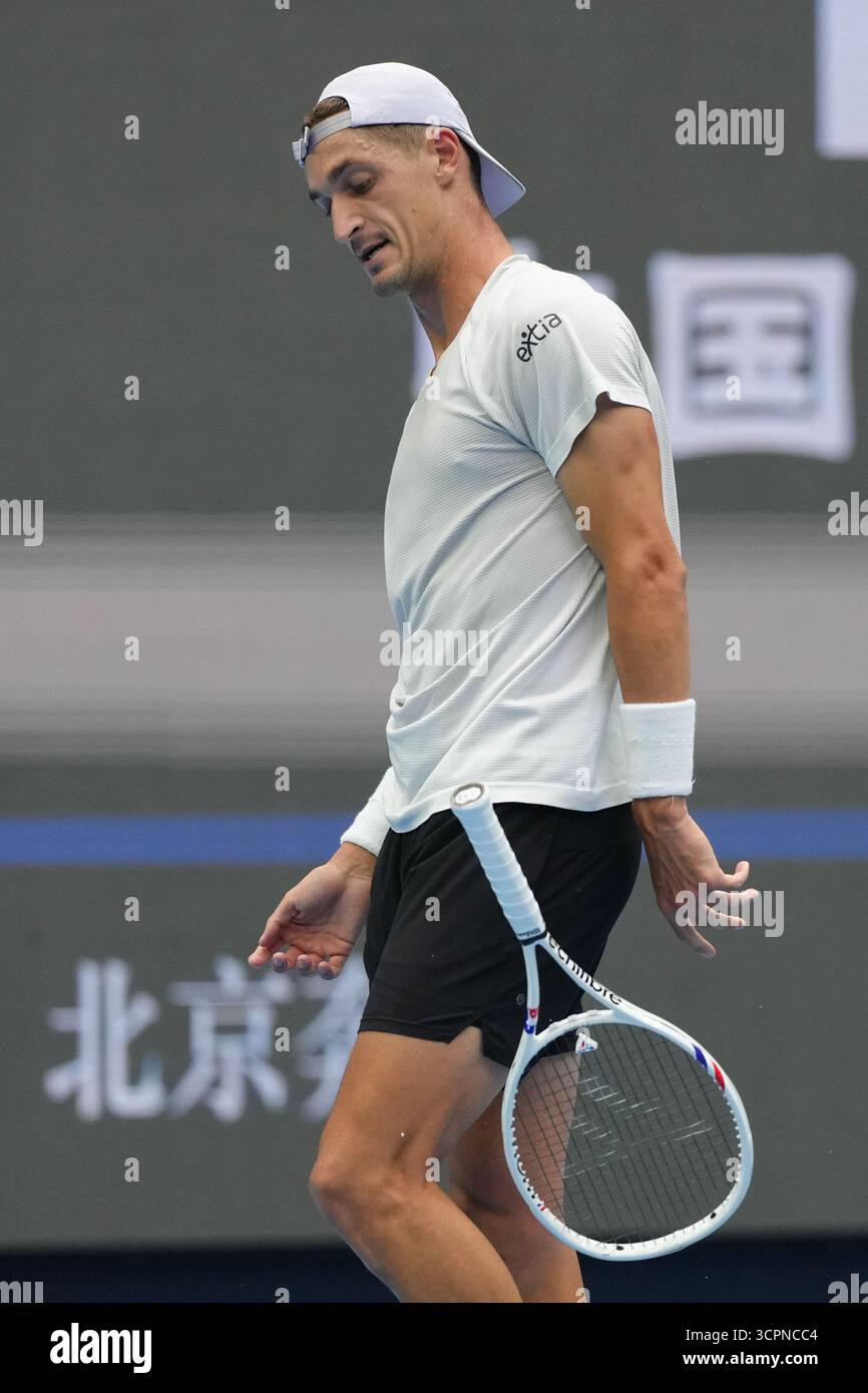 Terence Atmane, of France throws his racquet after losing a point to ...