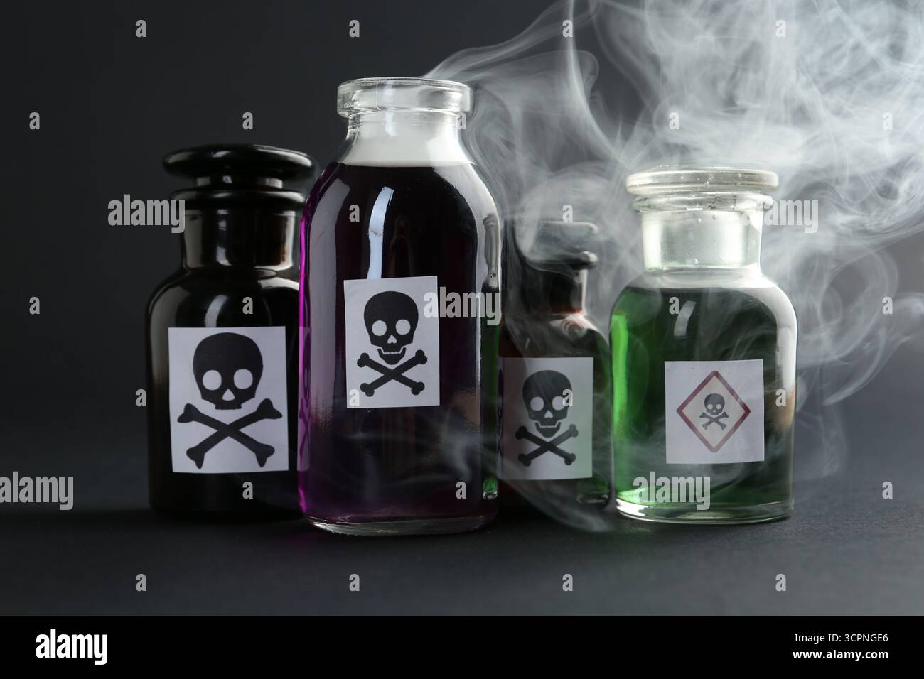Bottles of poison with warning signs and smoke on dark background ...