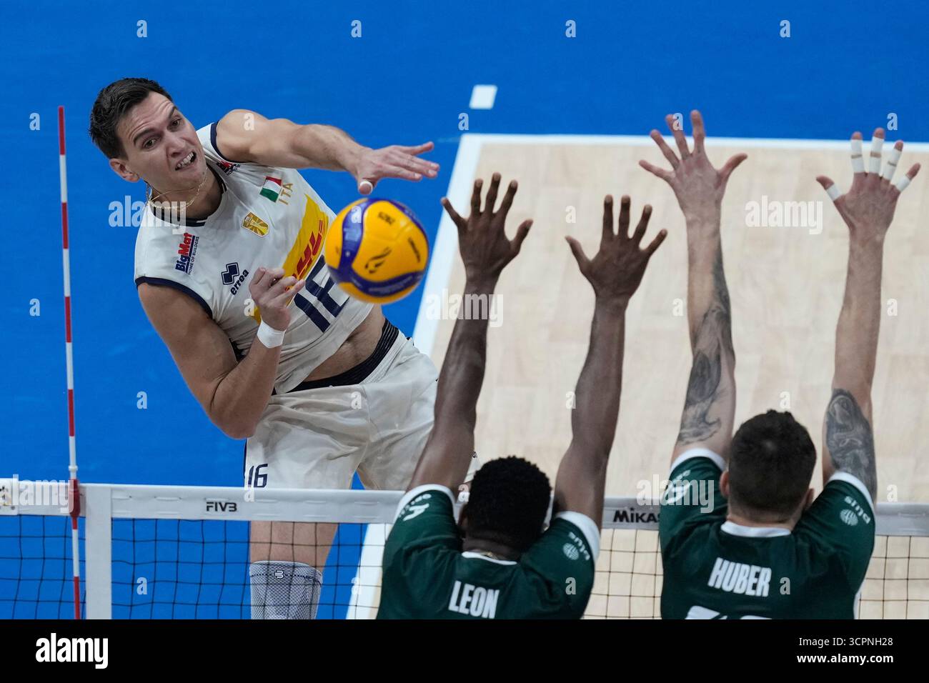 Yuri Romano of Italy spikes against Wilfredo Leon Venero bottom left ...