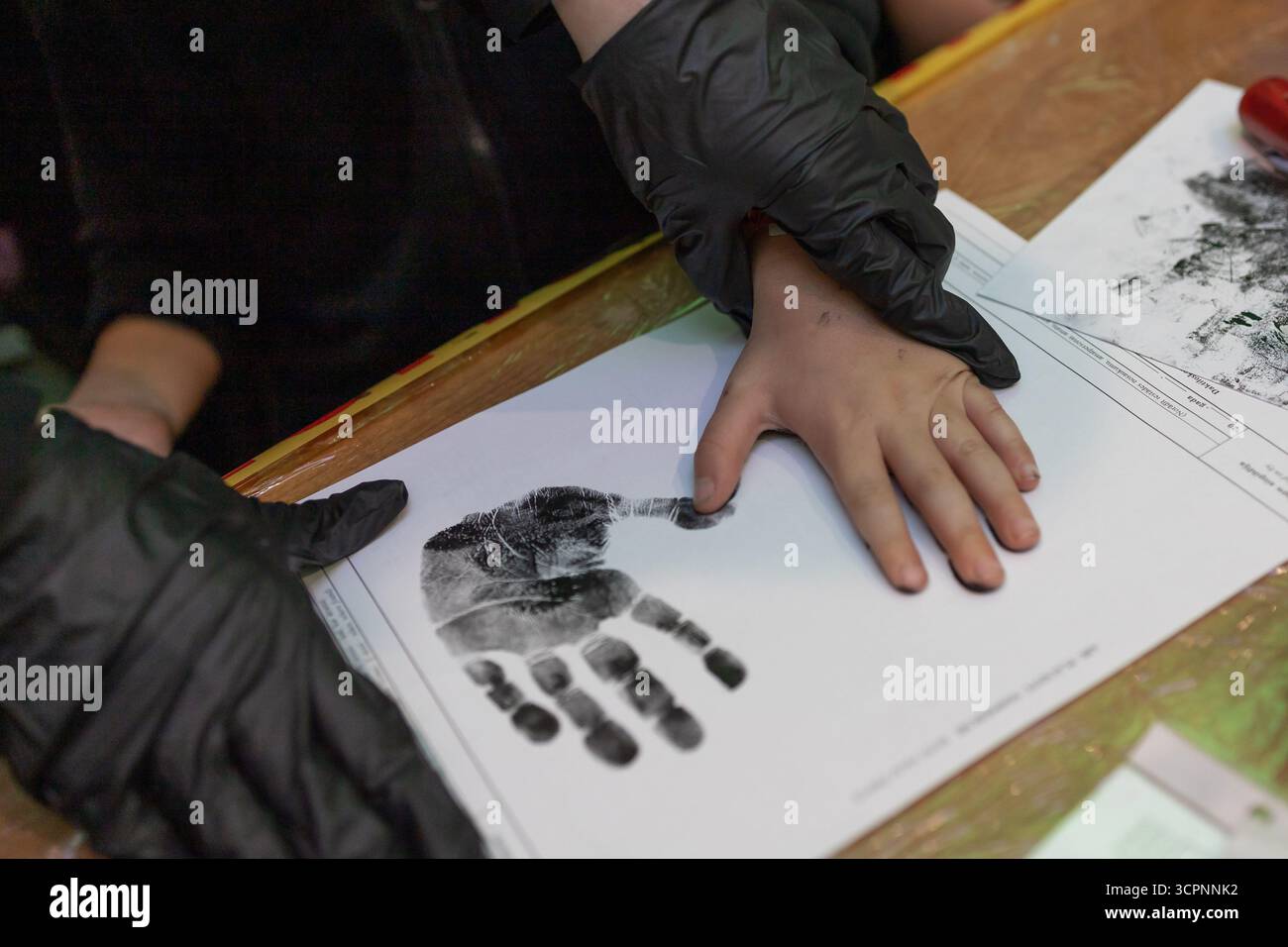 Taking of suspect's fingerprints in police department, close-up. Hand ...