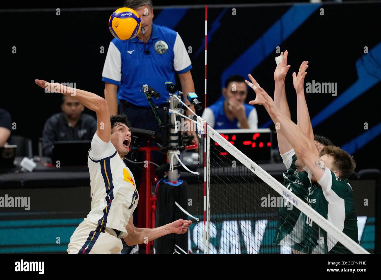 Mattia Bottolo of Italy, left, spikes against Poland during their ...