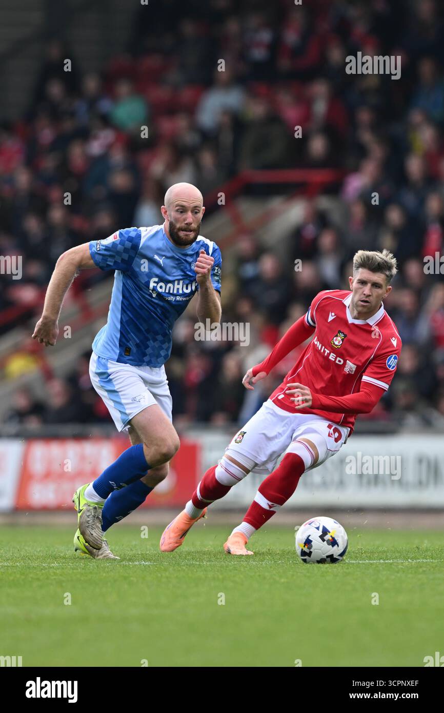 Derby County's Matthew Clarke (left) and Wrexham’s Josh Windass battle ...