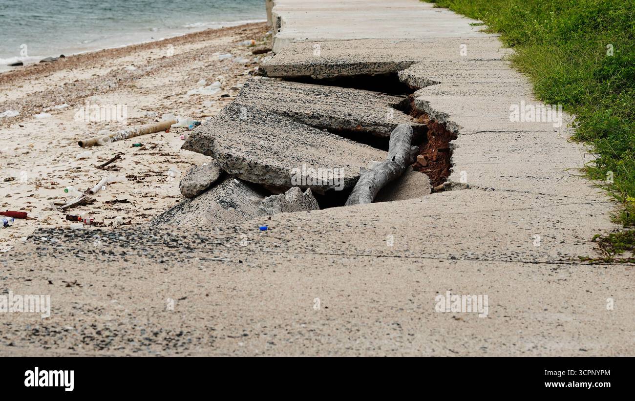 Cracked and collapsed coastal road severely damaged by sea erosion and ...