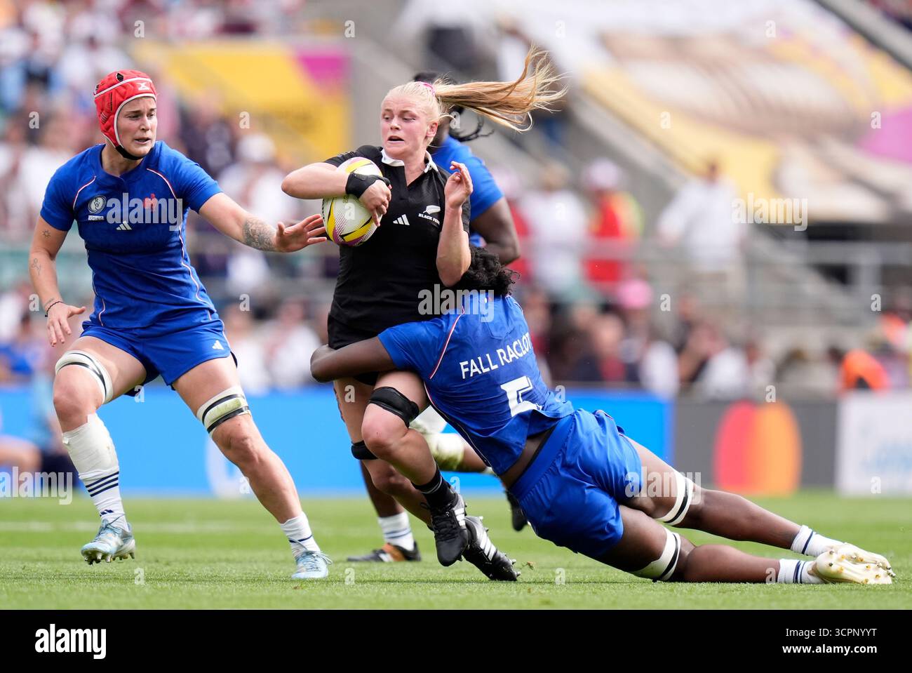 New Zealand's Jorja Miller (centre) is tackled by France's Madoussou ...
