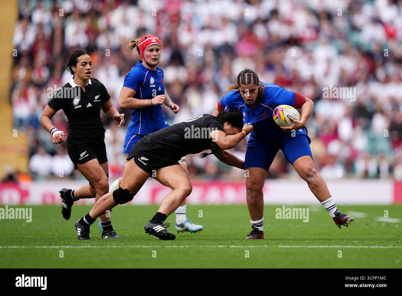 France's Annaelle Deshaye (right) is tackled by New Zealand's Ruahei ...
