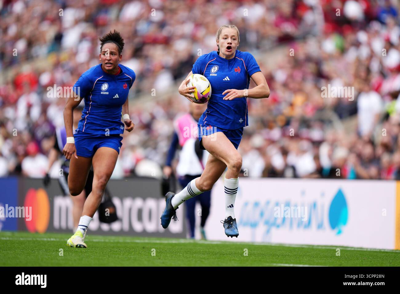 France's Emilie Boulard (right) runs in to score a try during the Women ...