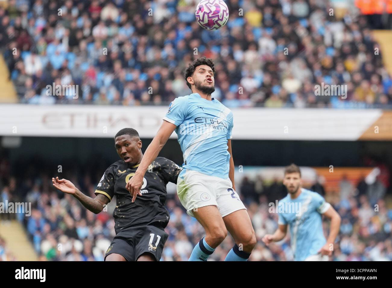 Manchester City's Matheus Nunes jumps for the ball in front of Burnley ...