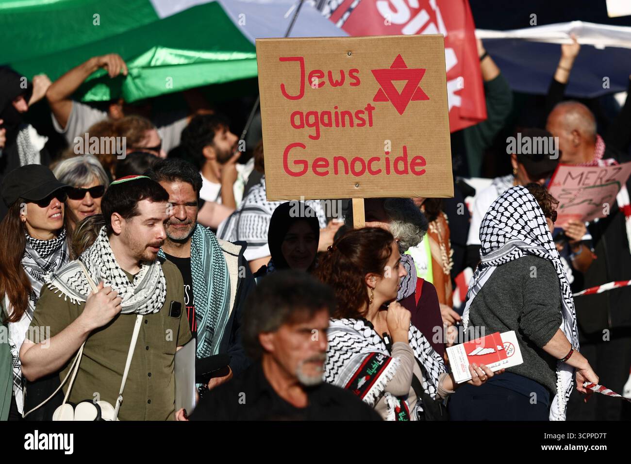 People hold a sign reading "Jews against genocide" during a mass ...