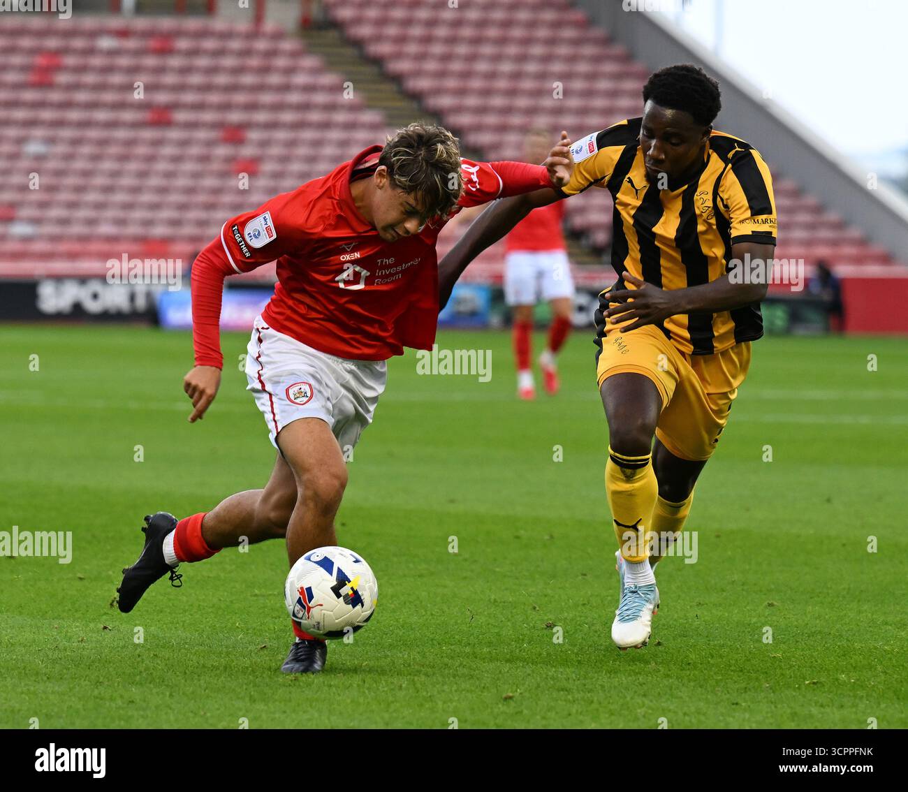 Barnsley's Caylan Vickers battles for the ball against Port Vale's ...