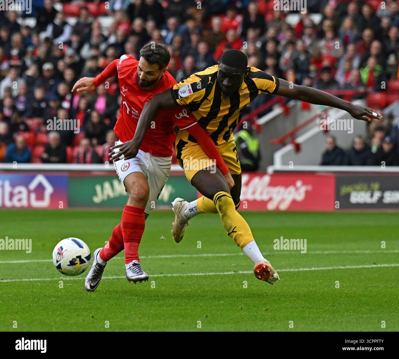 Barnsley's Adam Phillips battles for the ball against Port Vale's Jesse ...